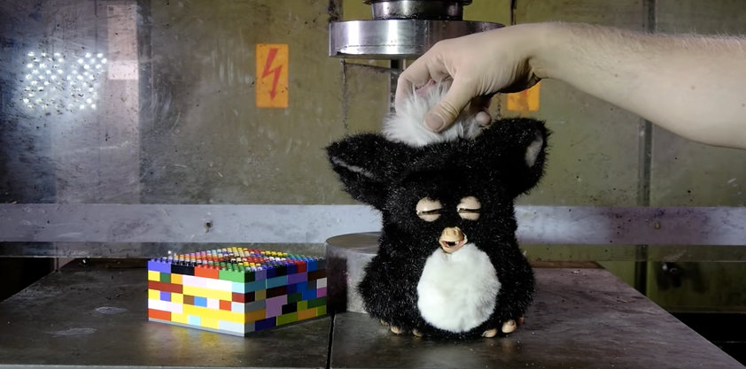 Watch a Furby get crushed, and bleed as it dies